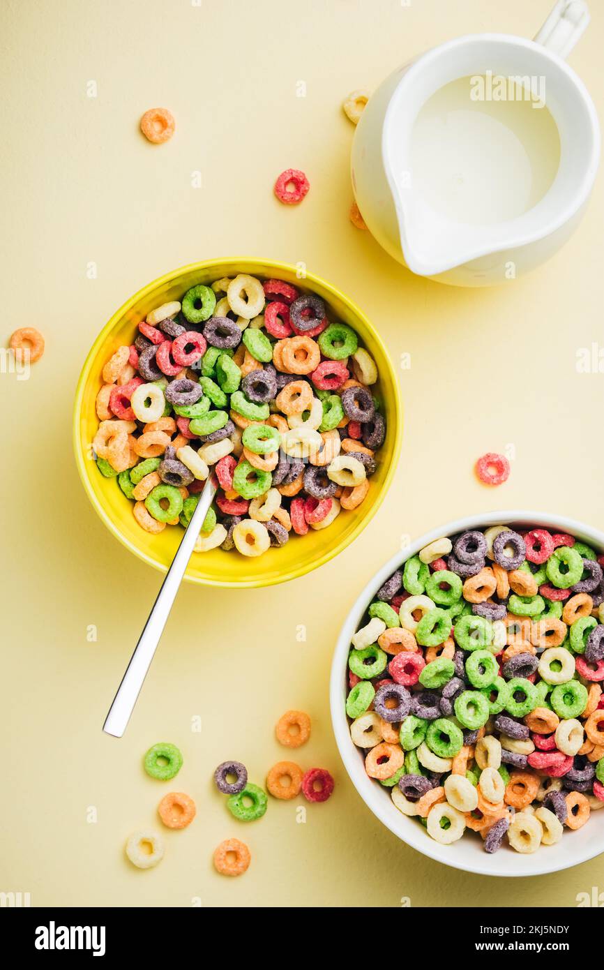 Colorful corn rings in bowl on yellow background. Ring-shaped sweet ...