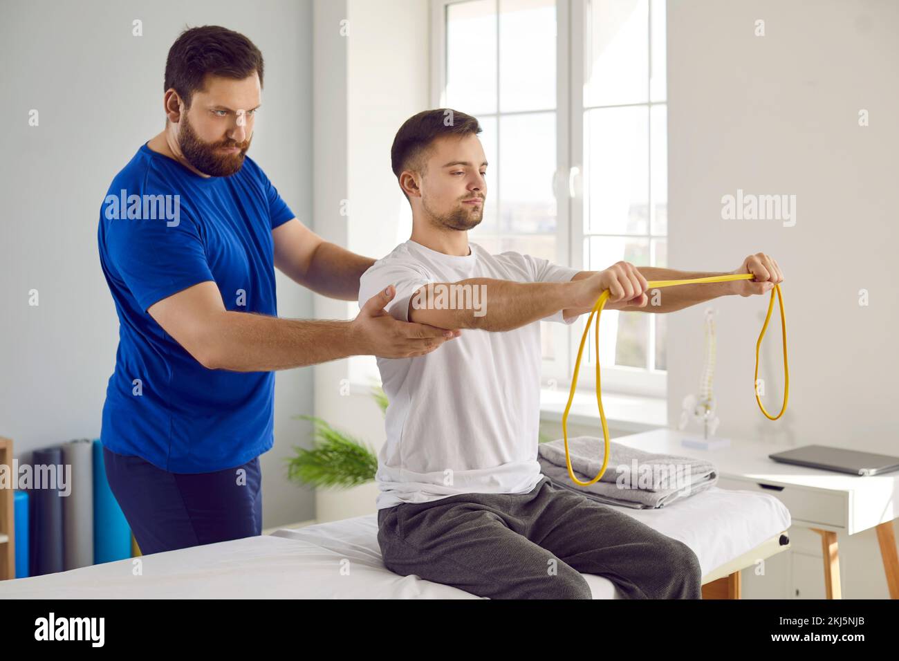 Physiotherapist's patient doing physical rehabilitation exercises with ...