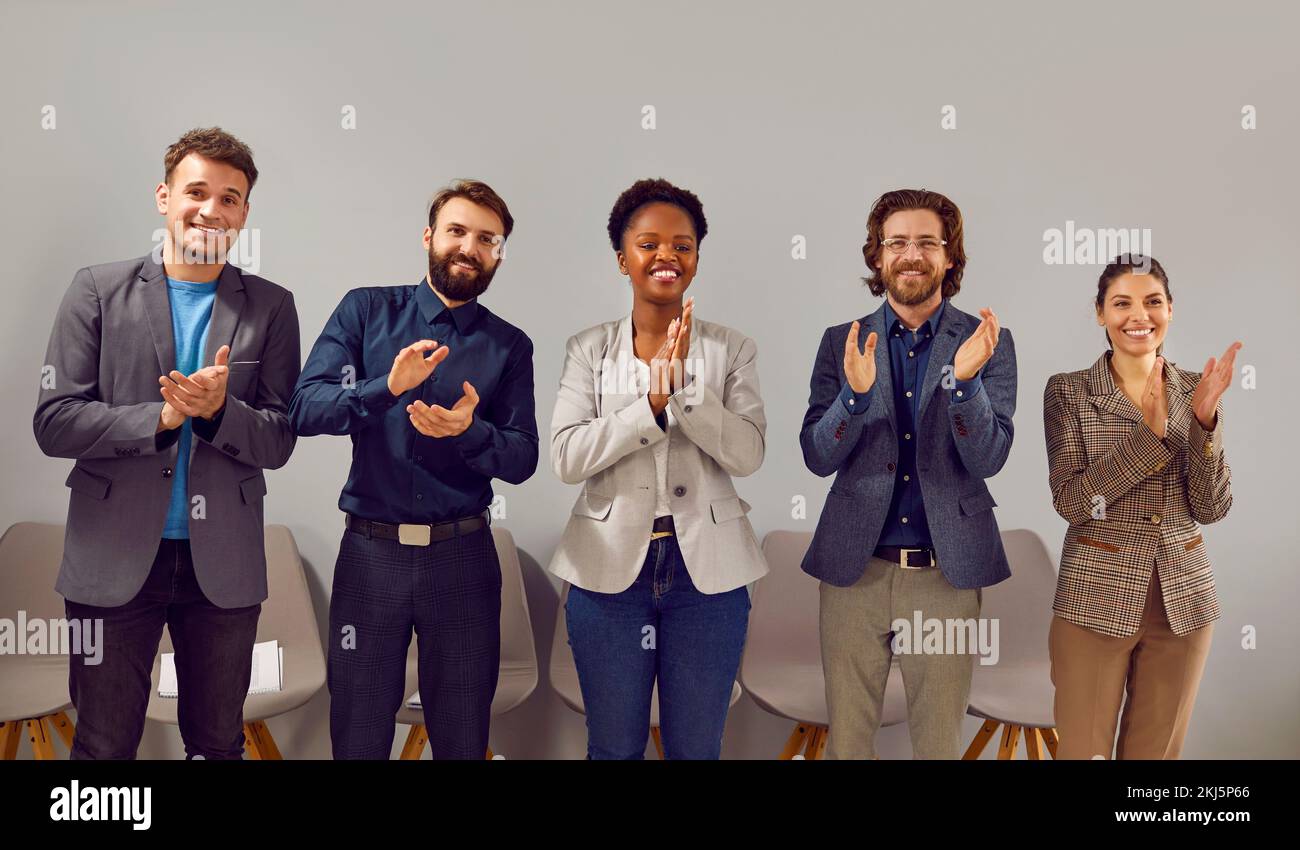 Young multinational people employees large company with smile applaud ...