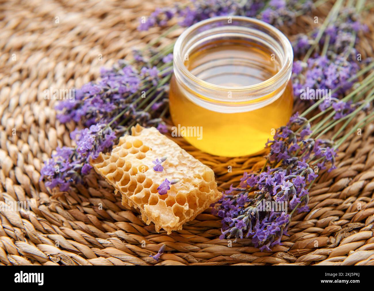 Glass of honey, honeycomb and lavender flowers Stock Photo - Alamy
