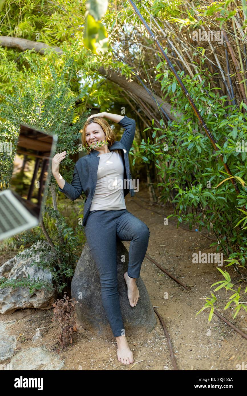 A beautiful freelancer woman works at the park using a computer Stock ...