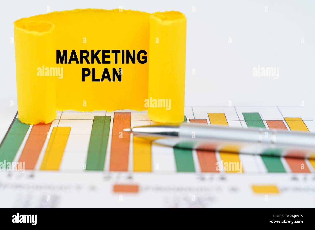 Business concept. On the business charts are a pen and a paper plate ...
