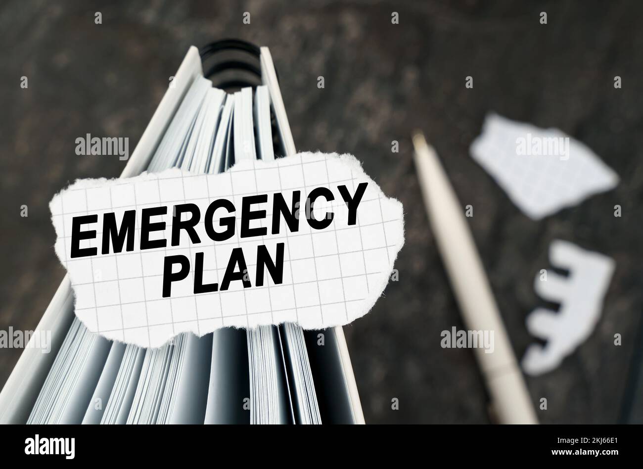 On the table is a notebook on which lies a piece of torn paper with the ...