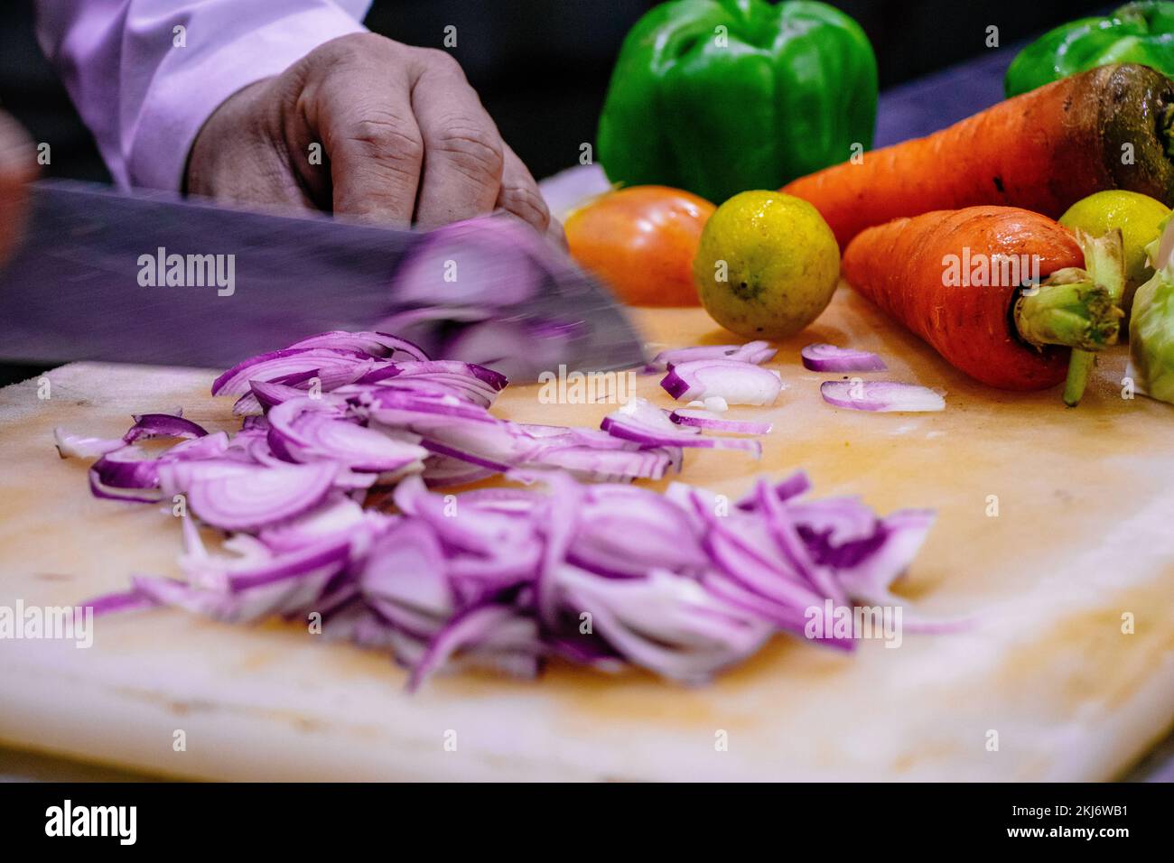 Chef Chopping Onion on a Chopping Board and preparing a meal Stock ...