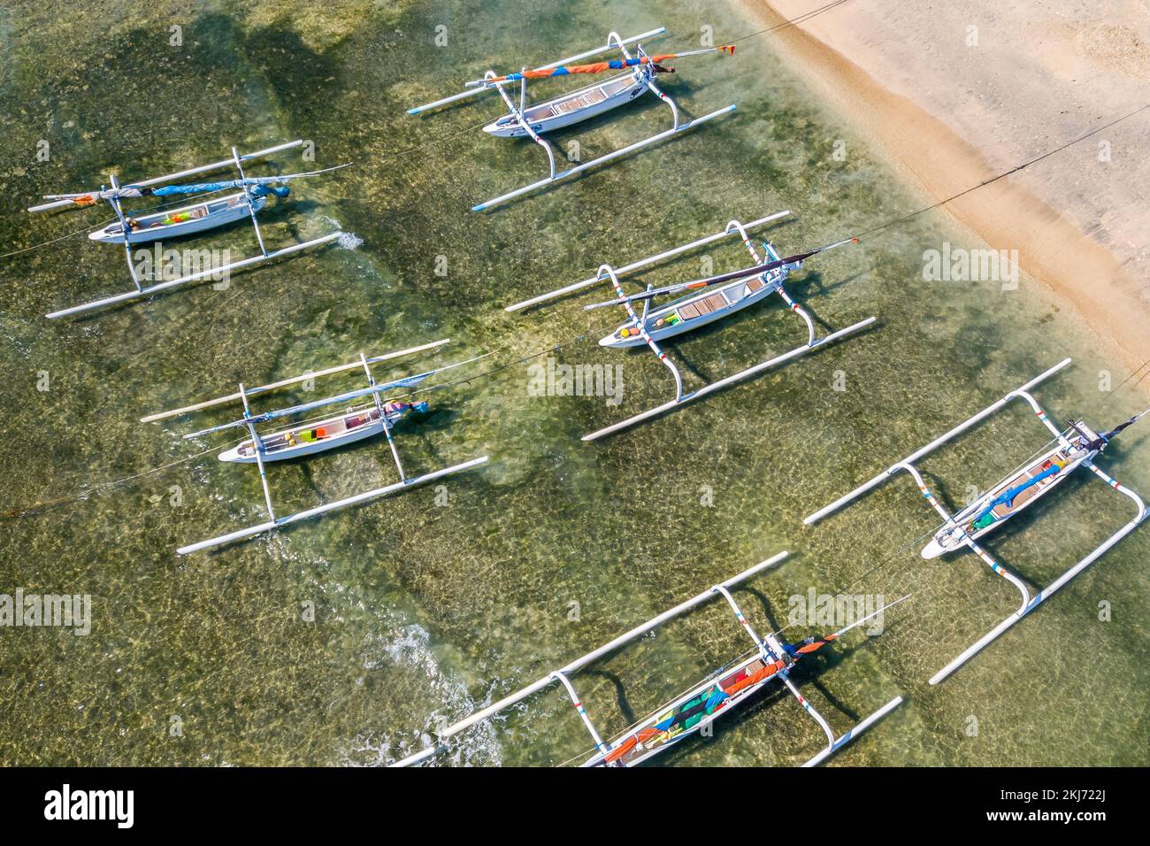 A top-down view of a group of traditional Balinese fishing boats moored ...