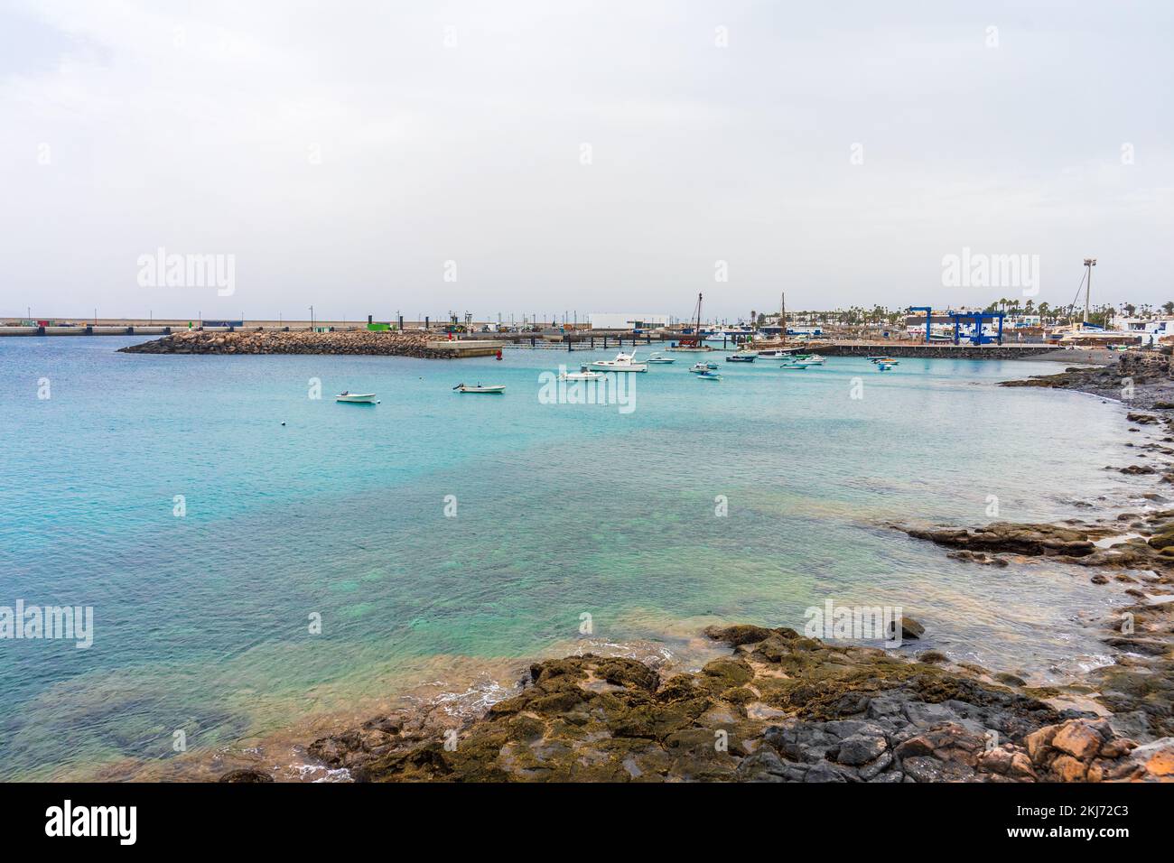 Coastline of Playa Blanca. In the background is the sea port. Playa ...