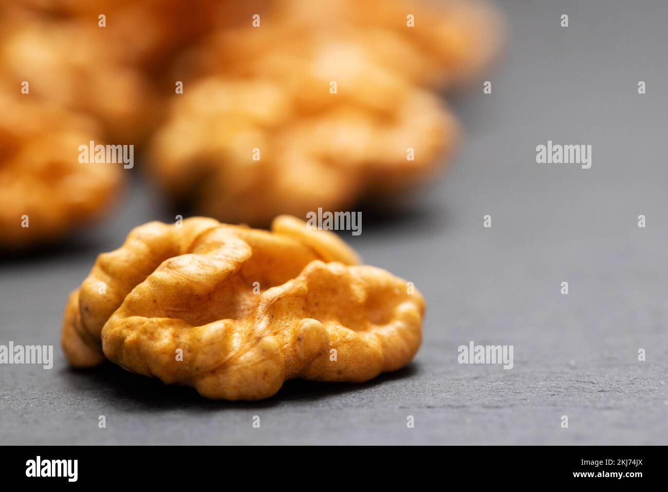 Walnuts. Walnut kernels on dark stone table. Vegetarian or healthy food ...