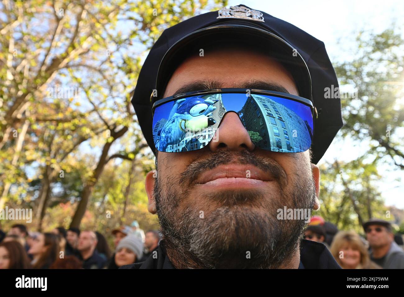 Bluey, a new balloon, is reflected in the mirrored lenses of an NYPD ...