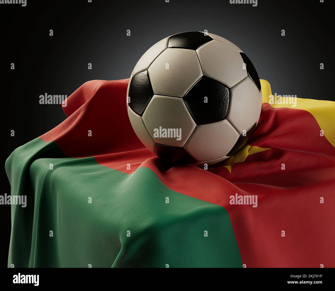 A regular soccer balls resting on a Cameroon flag draped over a plinth ...