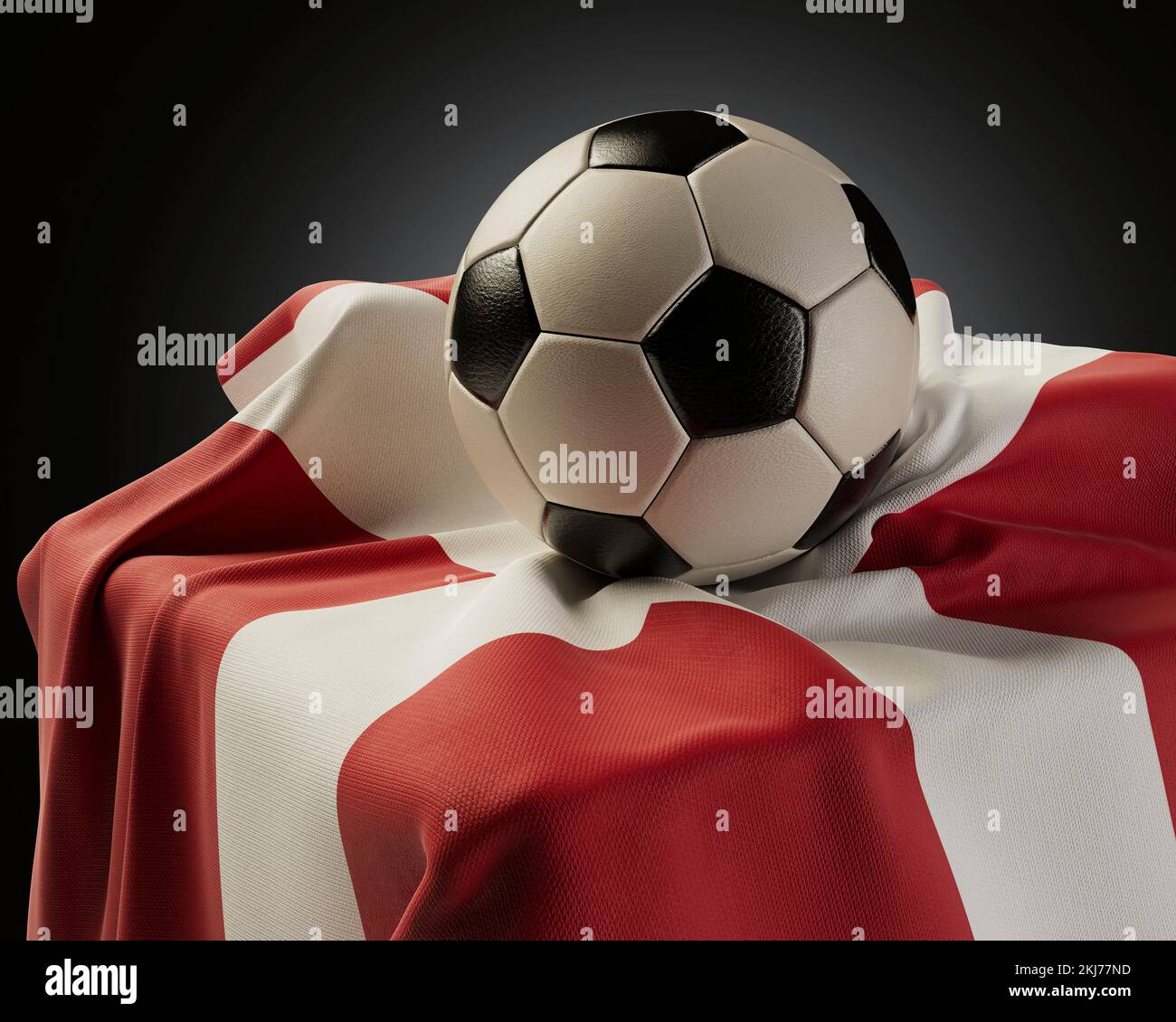A regular soccer balls resting on a Denmark flag draped over a plinth ...