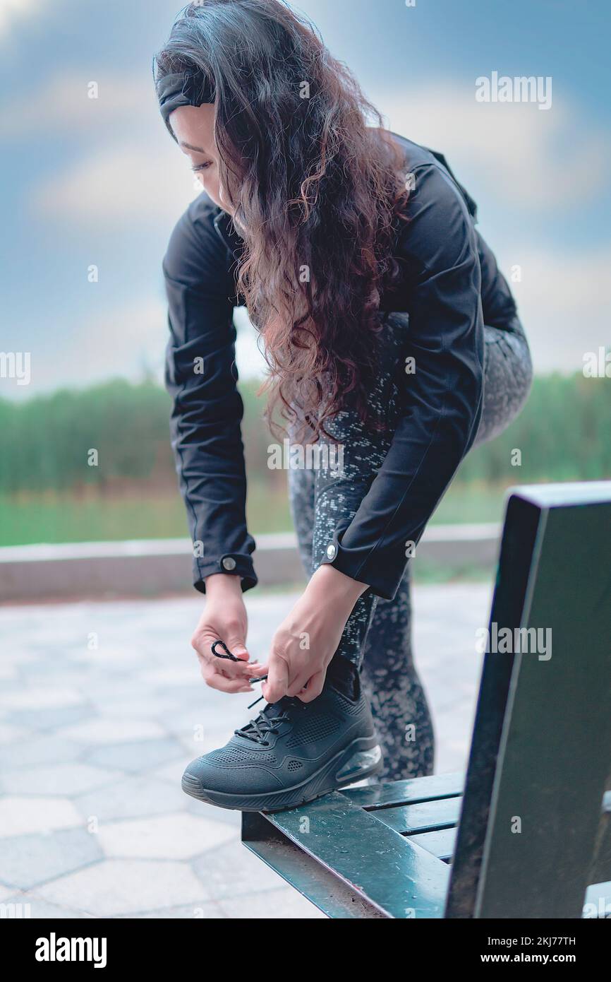 Sneakers. close up of a woman tying shoelaces. Women's sneaker ready ...