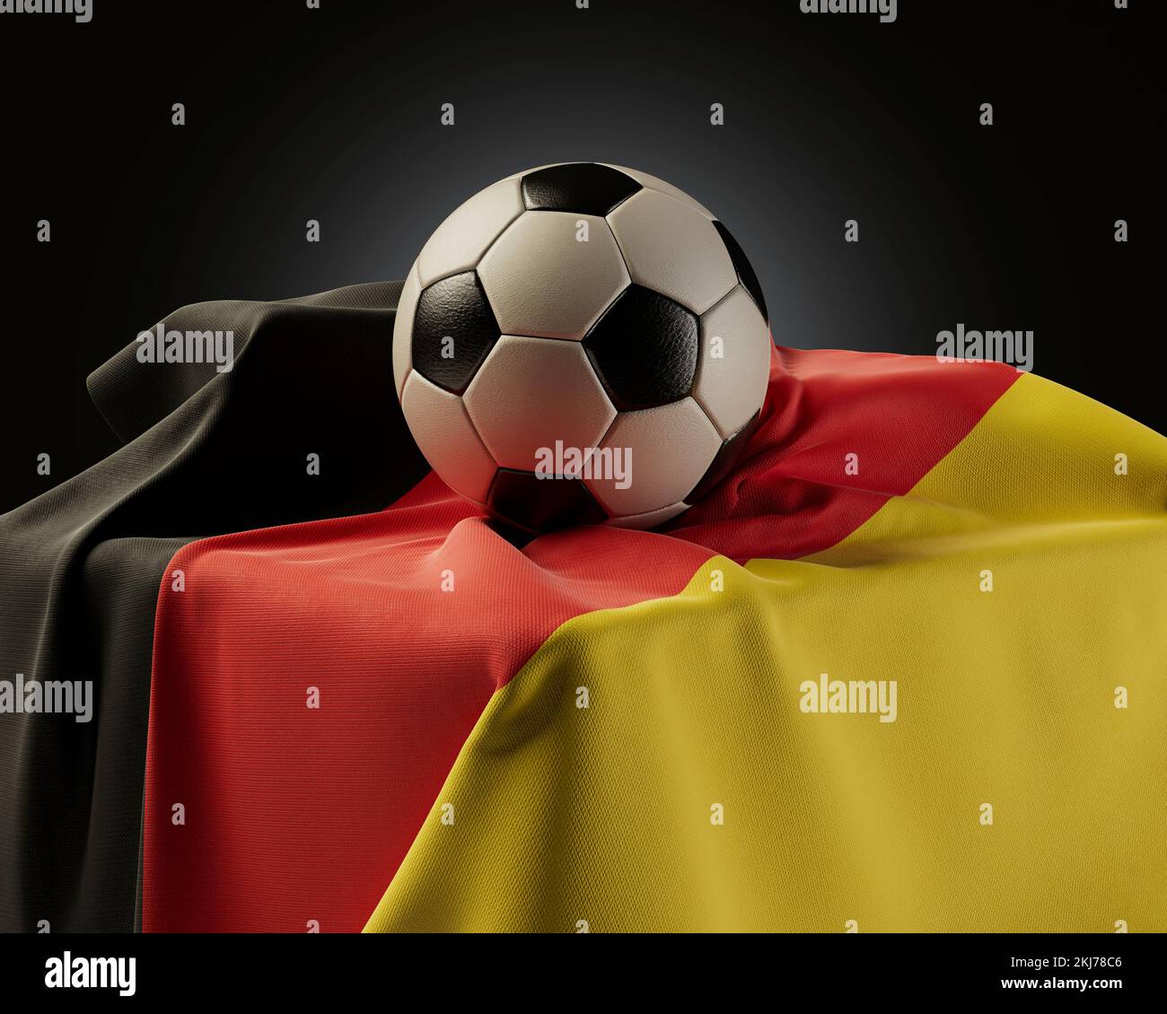 A regular soccer balls resting on a Germany flag draped over a plinth ...