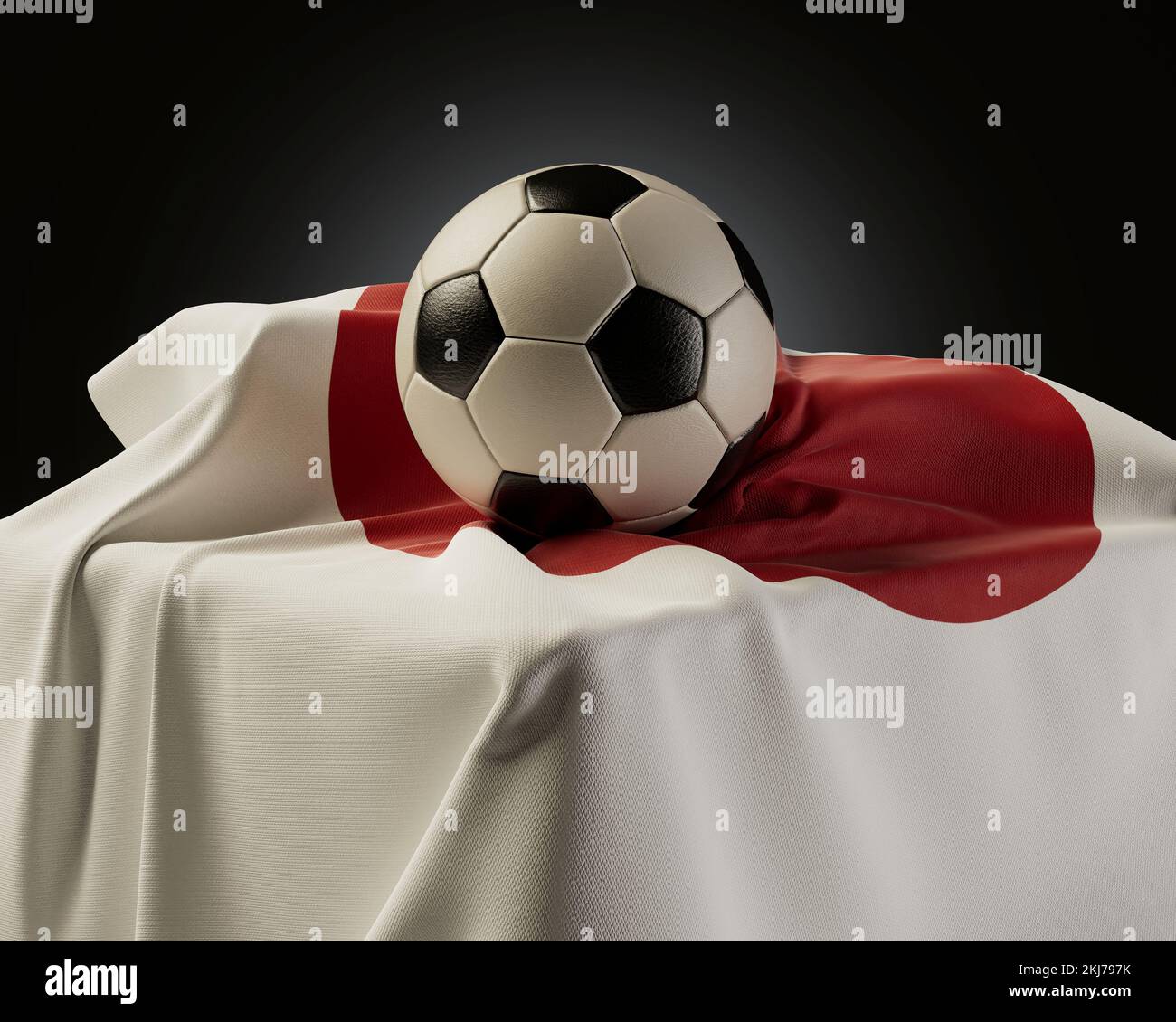 A regular soccer ball resting on a Japan flag draped over a plinth on ...
