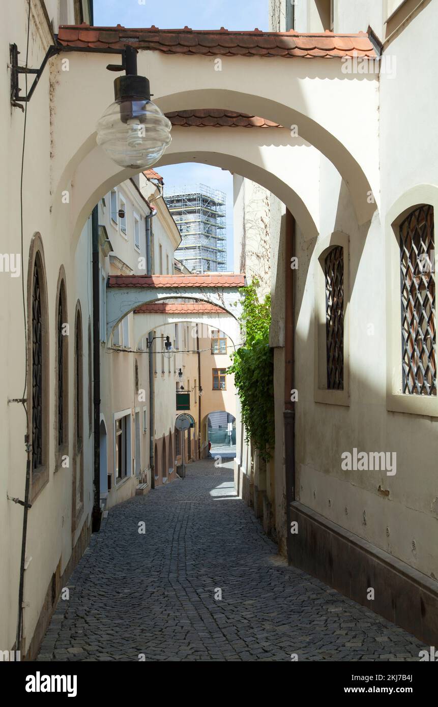 The narrow curved street with arches in Olomouc old town (Czech ...
