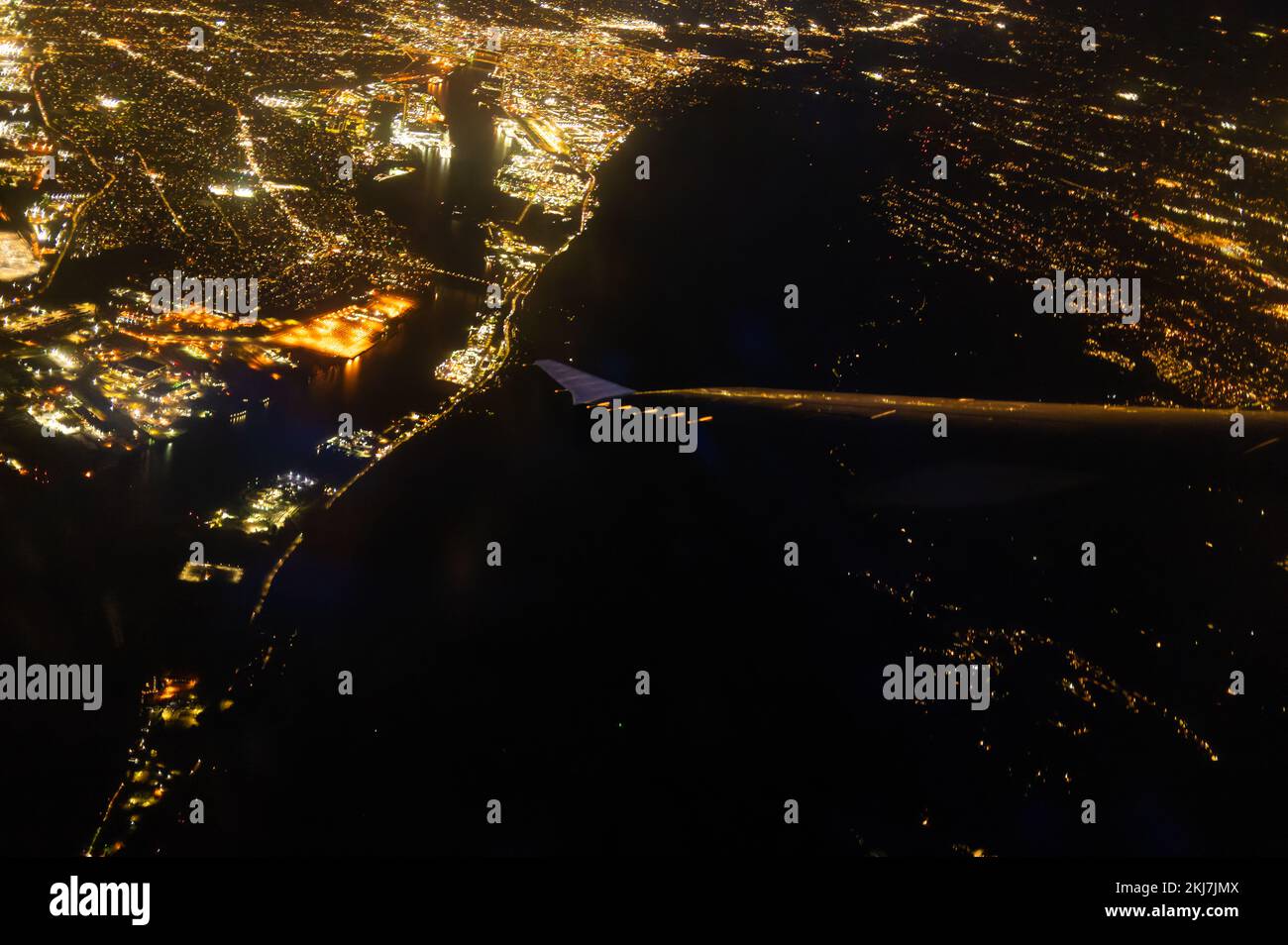 Fantastic bird's eye view of the night city in golden lights. Filming ...