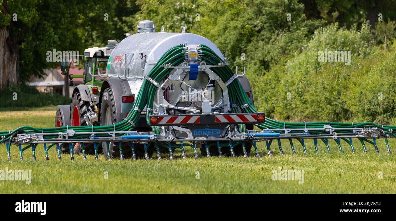 Weidenbach, Germany. 19th May, 2022. A tractor pulls a slurry tanker ...