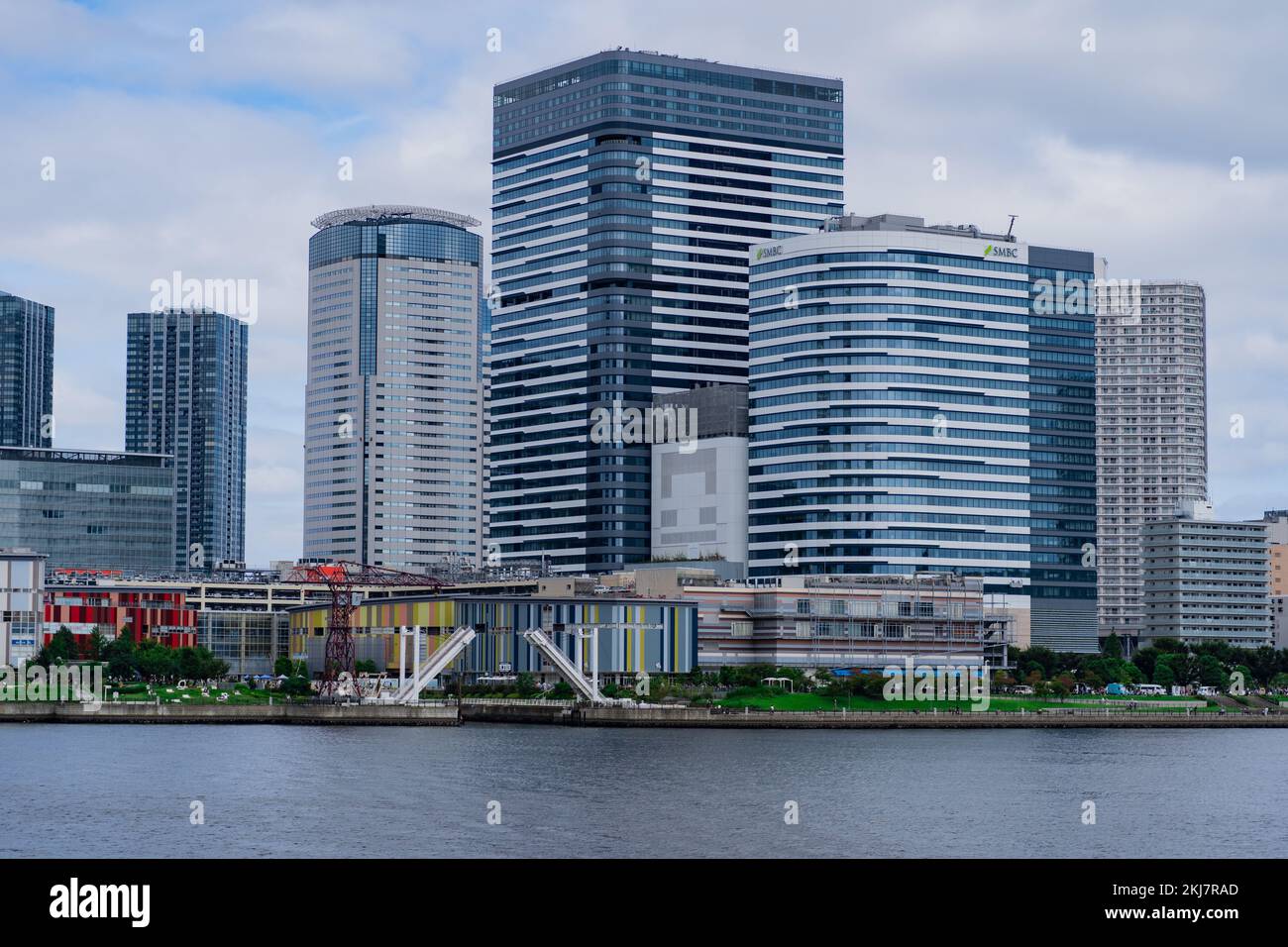 The skyline of Tokyo from the harbor with tall skyscrapers looming over ...