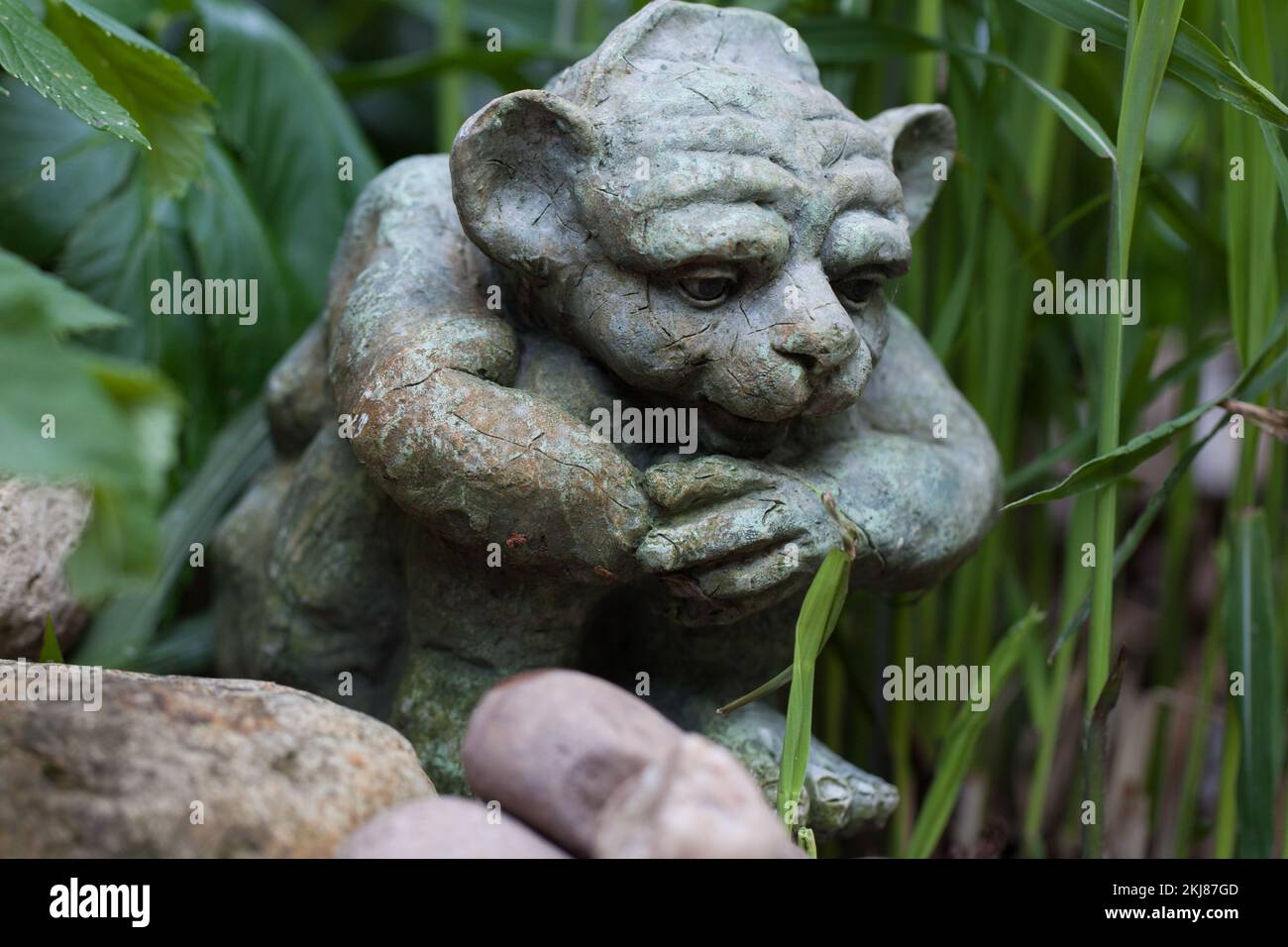 A statue of a goblin in a garden Stock Photo - Alamy