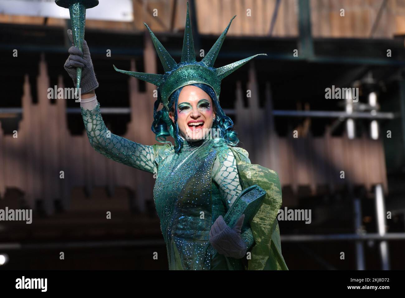 A performer dressed as the Statue of Liberty makes her way down Central ...