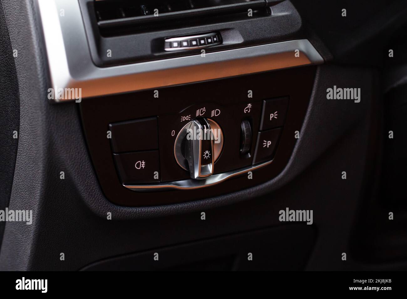 Closeup of the headlight switch control button. Lights control panel in ...