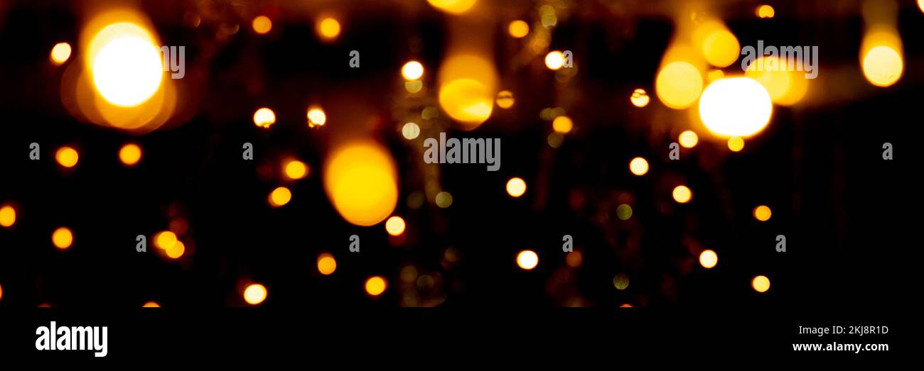 Blurry garland lights on a dark background. Festive Christmas and New ...