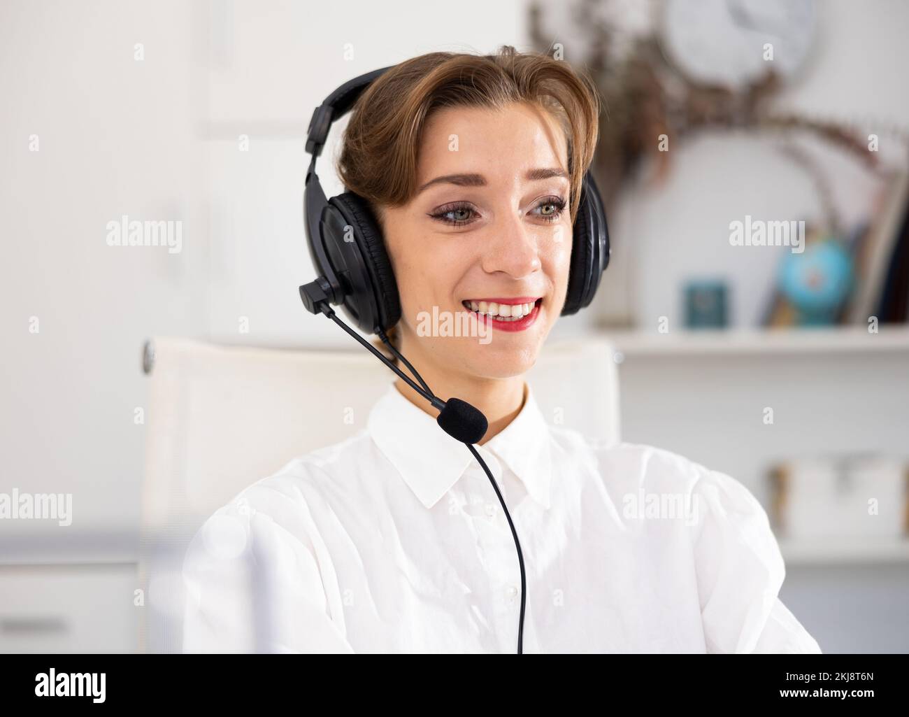 Female operator talking with customer using headset at company office ...