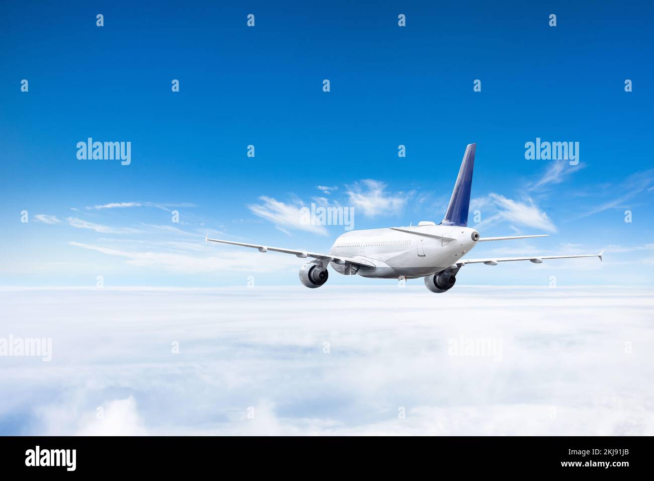 Airplane flies above the clouds high in the sky Stock Photo - Alamy