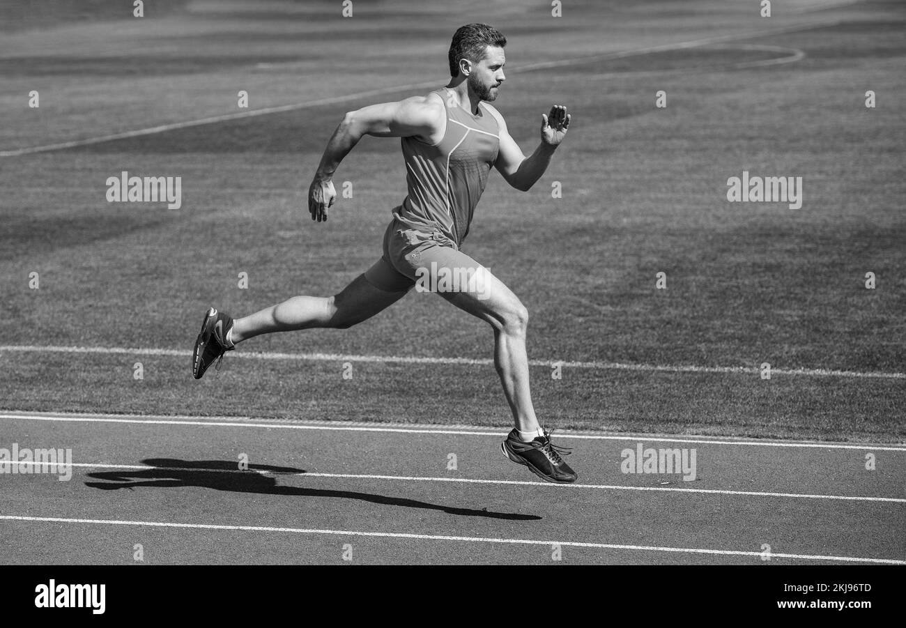 athletic muscular man running in sportswear on stadium track, stamina ...