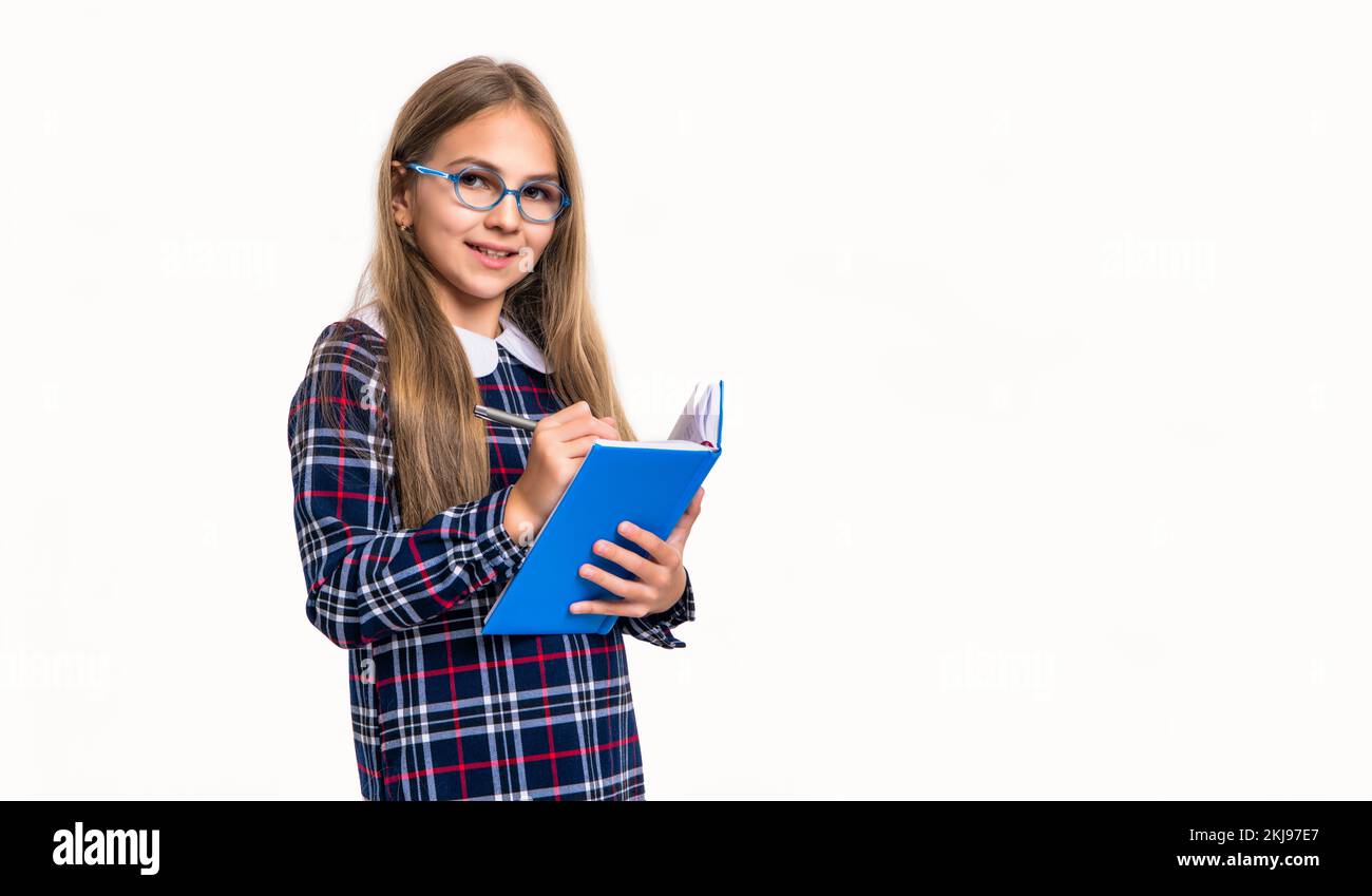 photo of school teen noting girl making notes, copy space. school girl ...