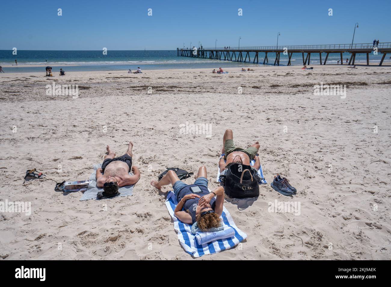 24 November 2022: People sunbathing on a beach in Adelaide, Australia ...