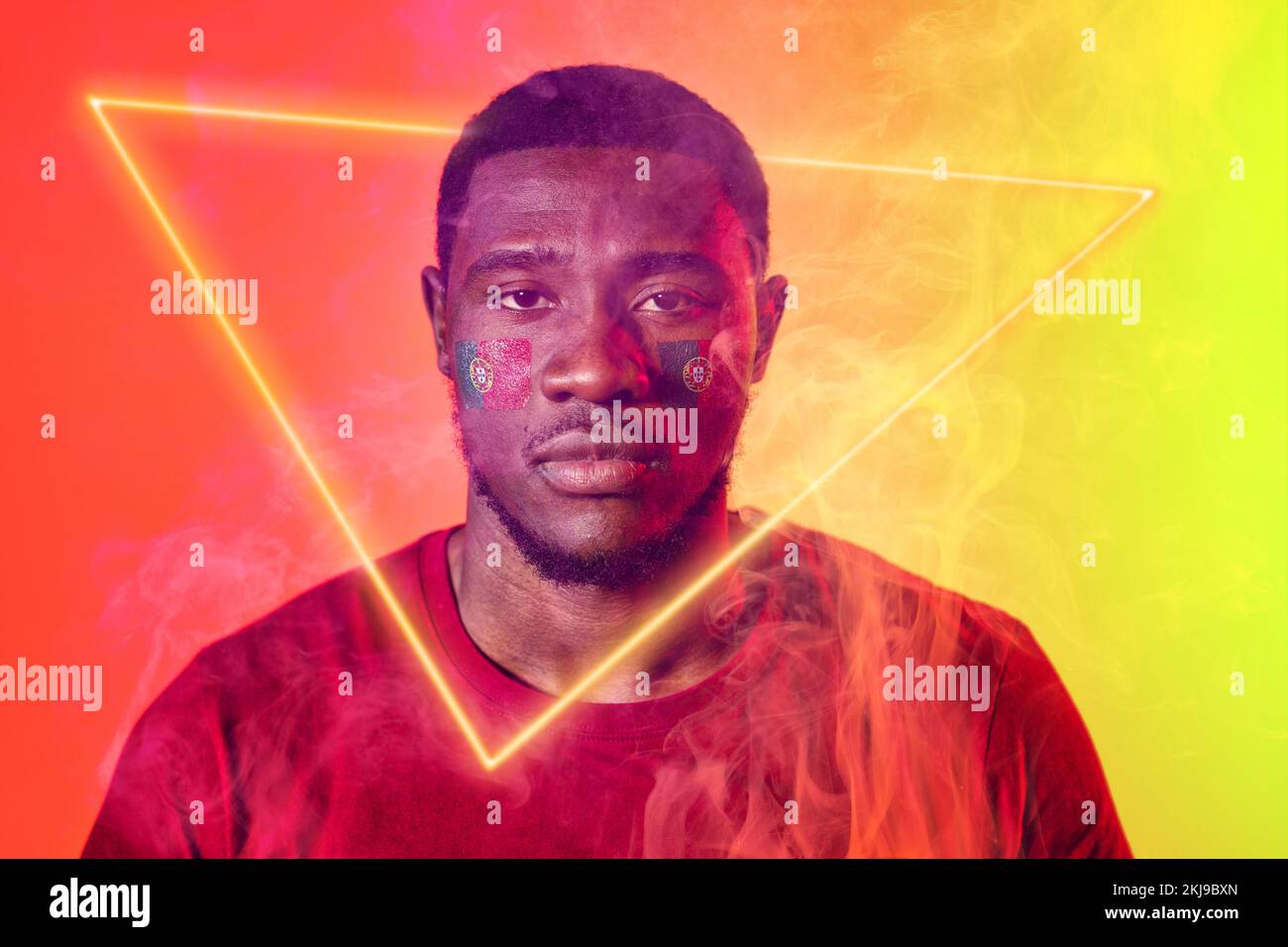 Portrait of african american male soccer player with portuguese flag on ...