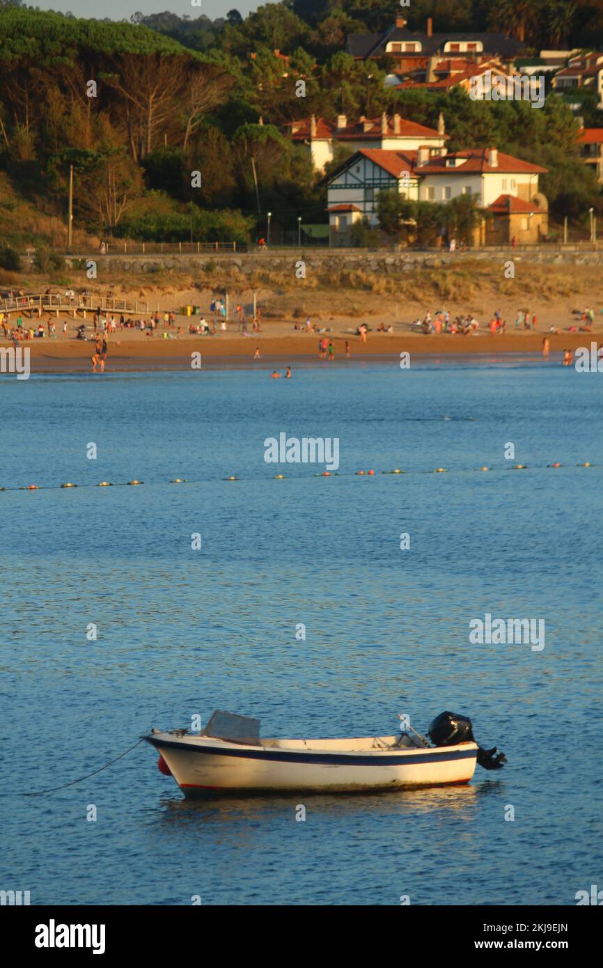 Boat floating in the Bay of Gorliz (Basque Country) in summer during ...