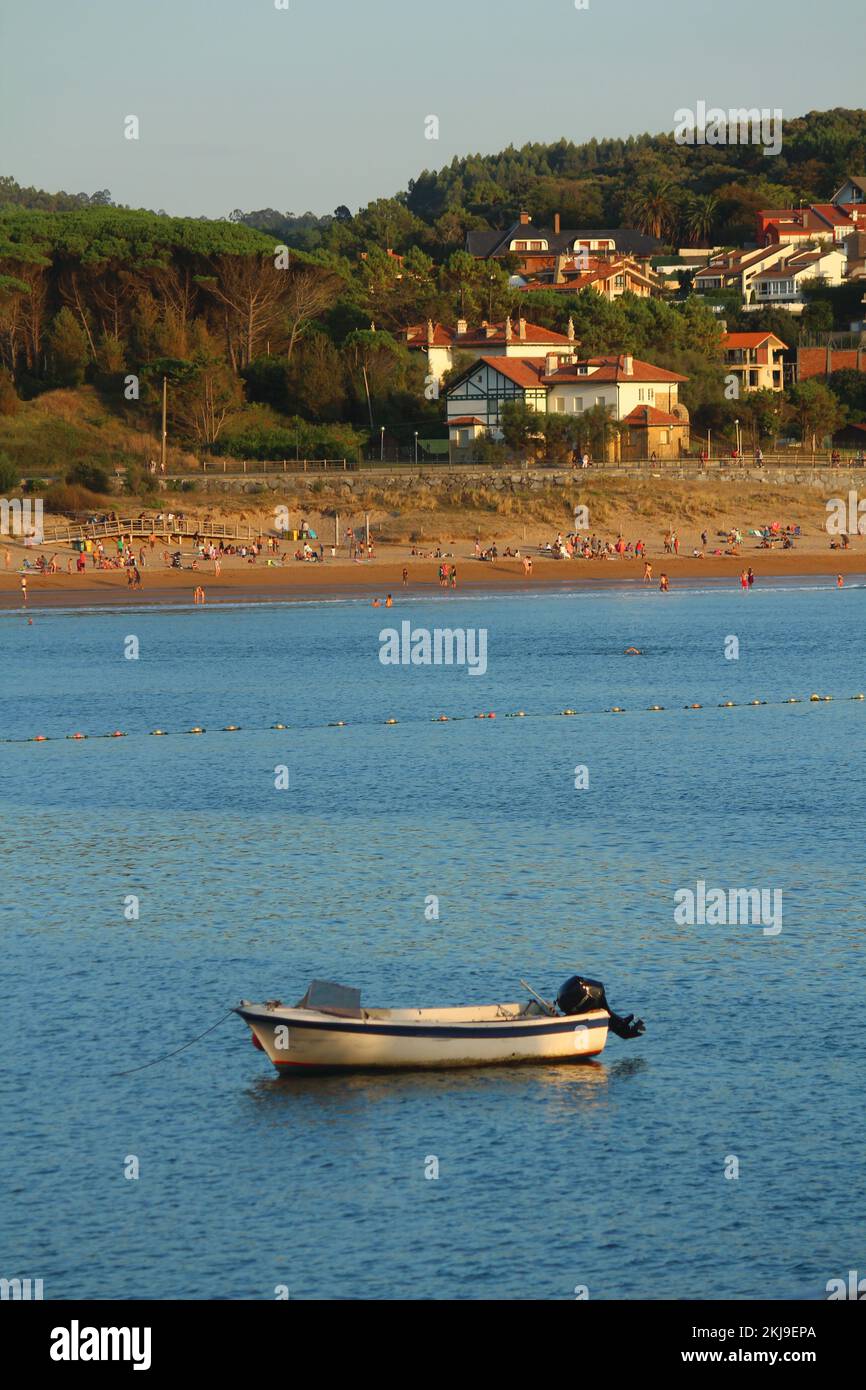 Boat floating in the Bay of Gorliz (Basque Country) in summer during ...