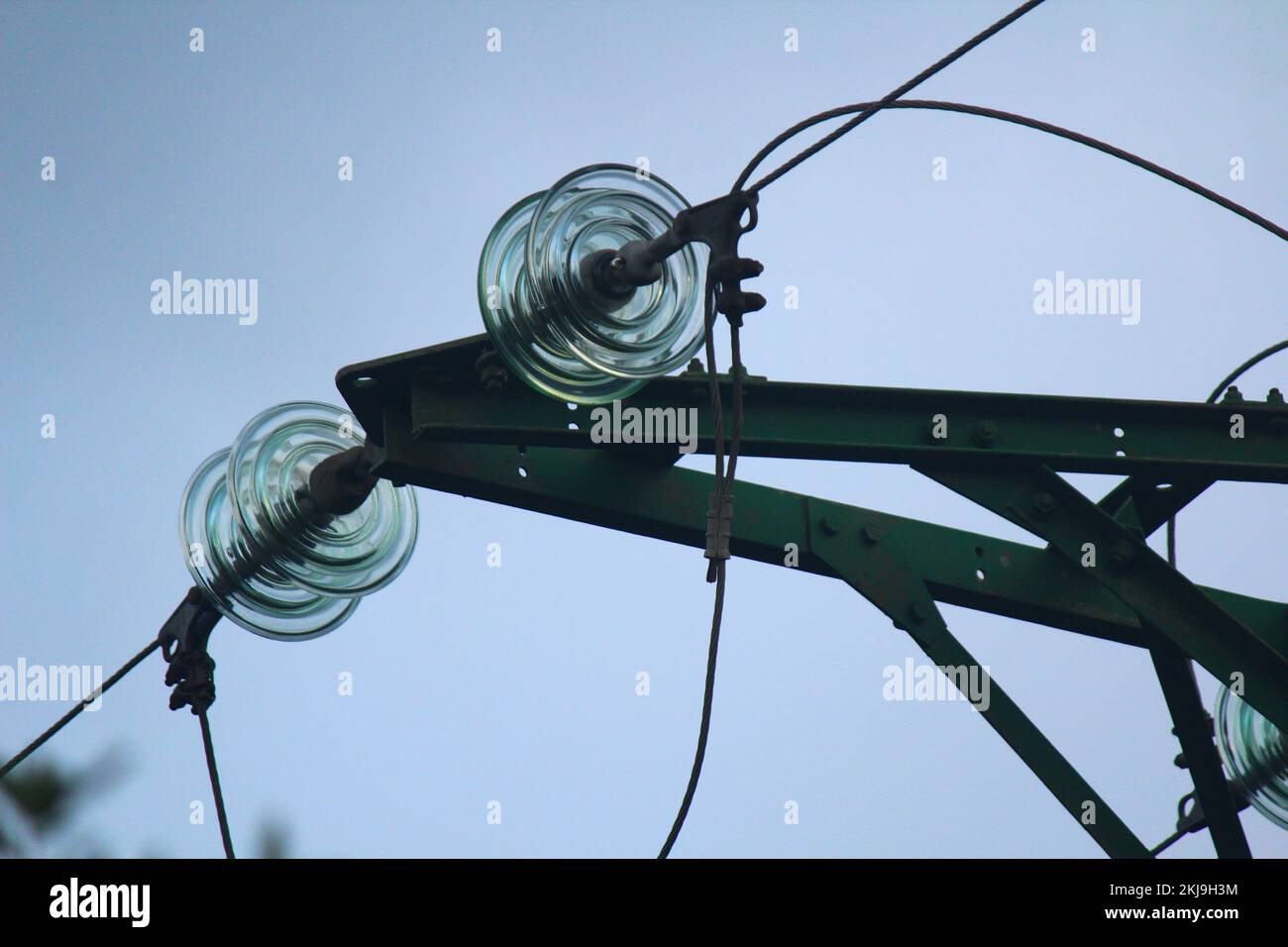 Electrical distribution wires on the top of a metal pole with glass ...
