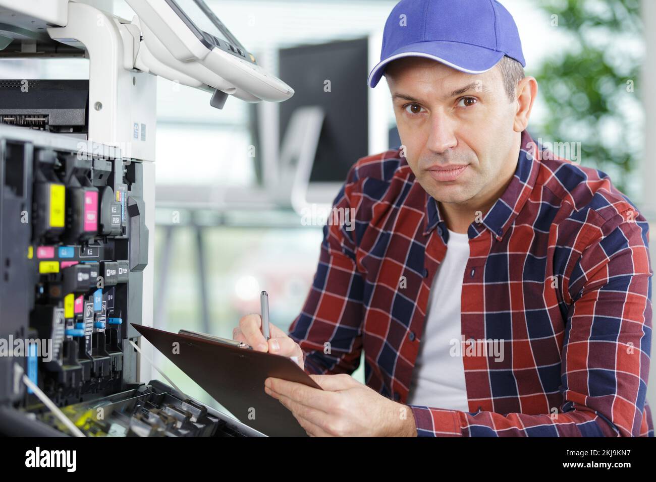 maintenance checks the level of ink of printer at work Stock Photo - Alamy
