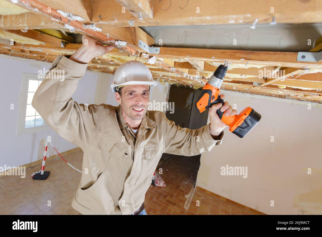 manual worker drilling ceiling with a drilling machine Stock Photo - Alamy