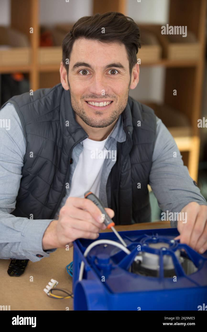 happy electrician installing a box Stock Photo - Alamy