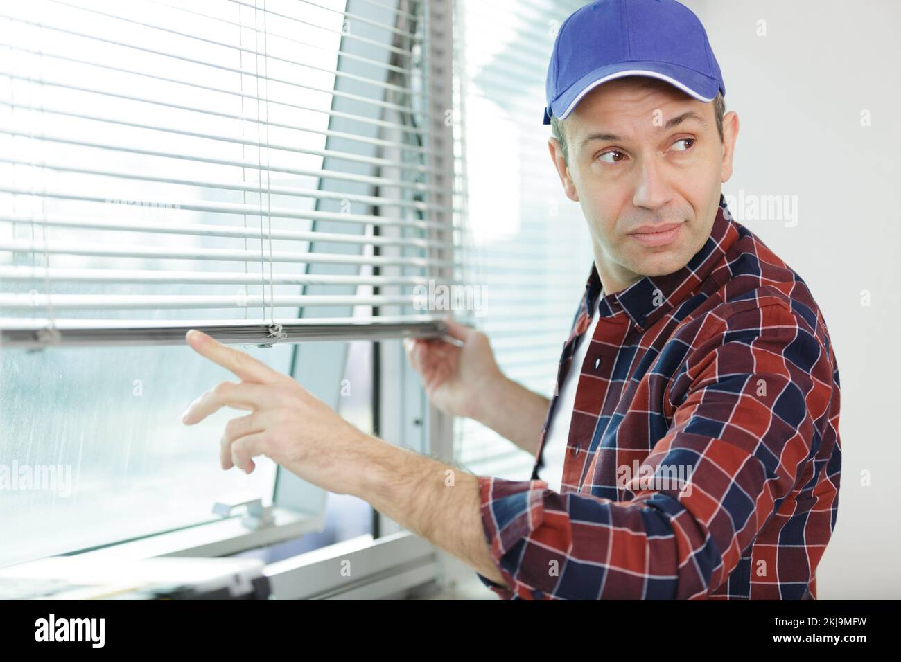male in helmet looking through window Stock Photo - Alamy