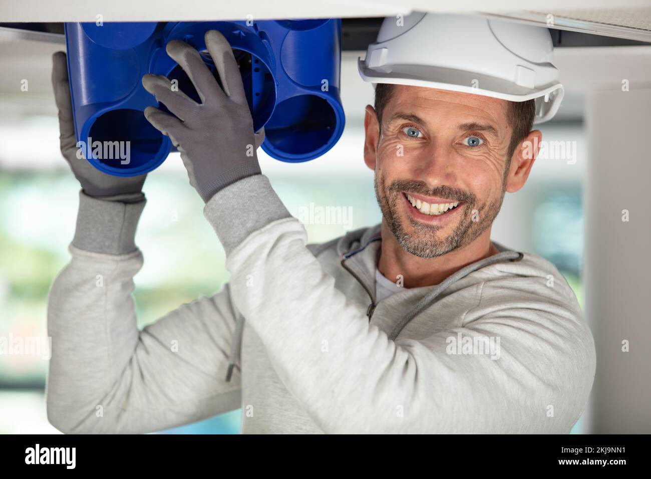 electrician installing device in new house Stock Photo - Alamy