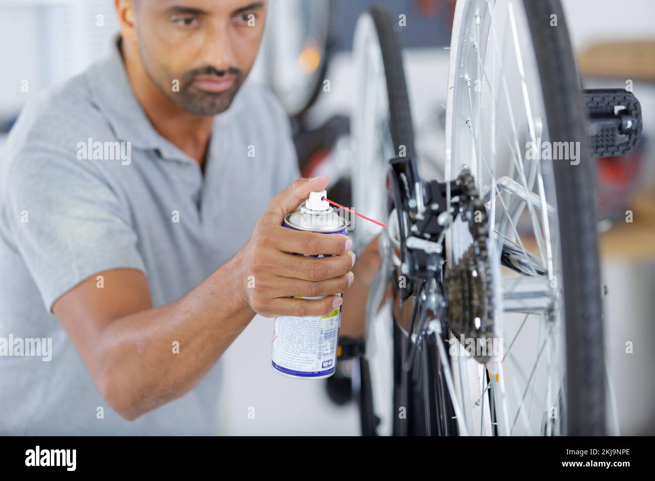 man adding oil on wheel bike Stock Photo - Alamy