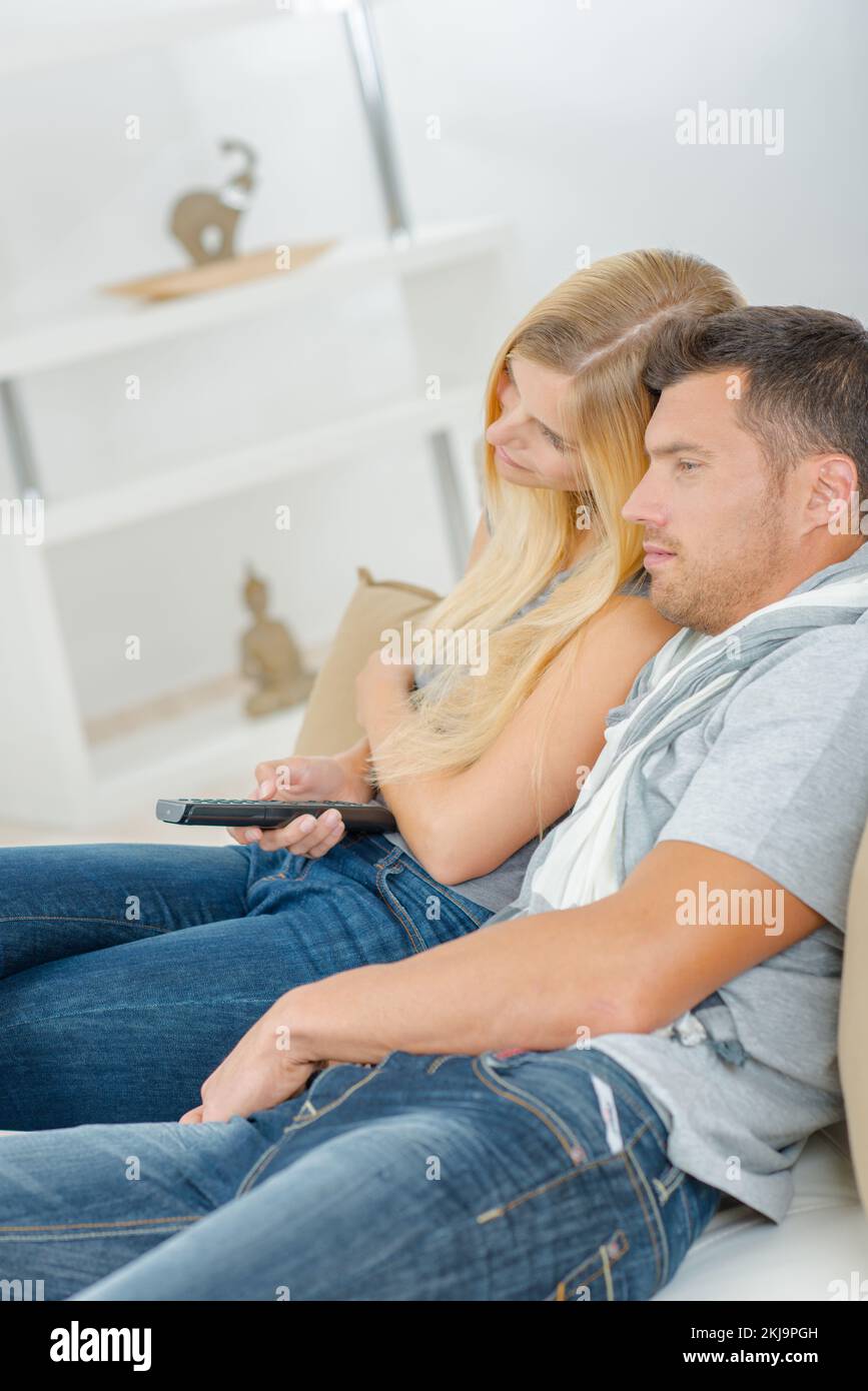 Playful couple fighting over the TV remote Stock Photo - Alamy