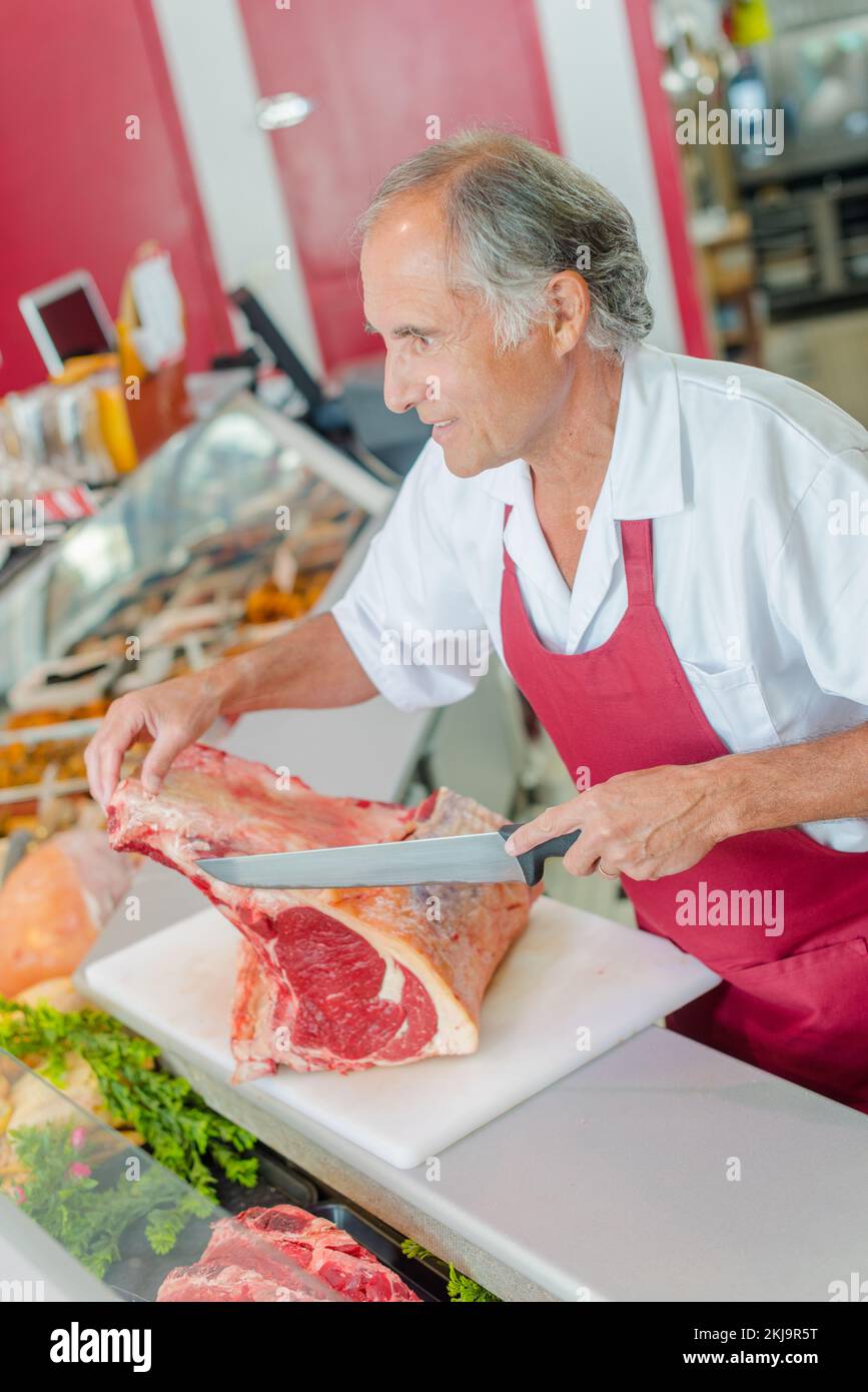 a butcher is rendering service Stock Photo - Alamy