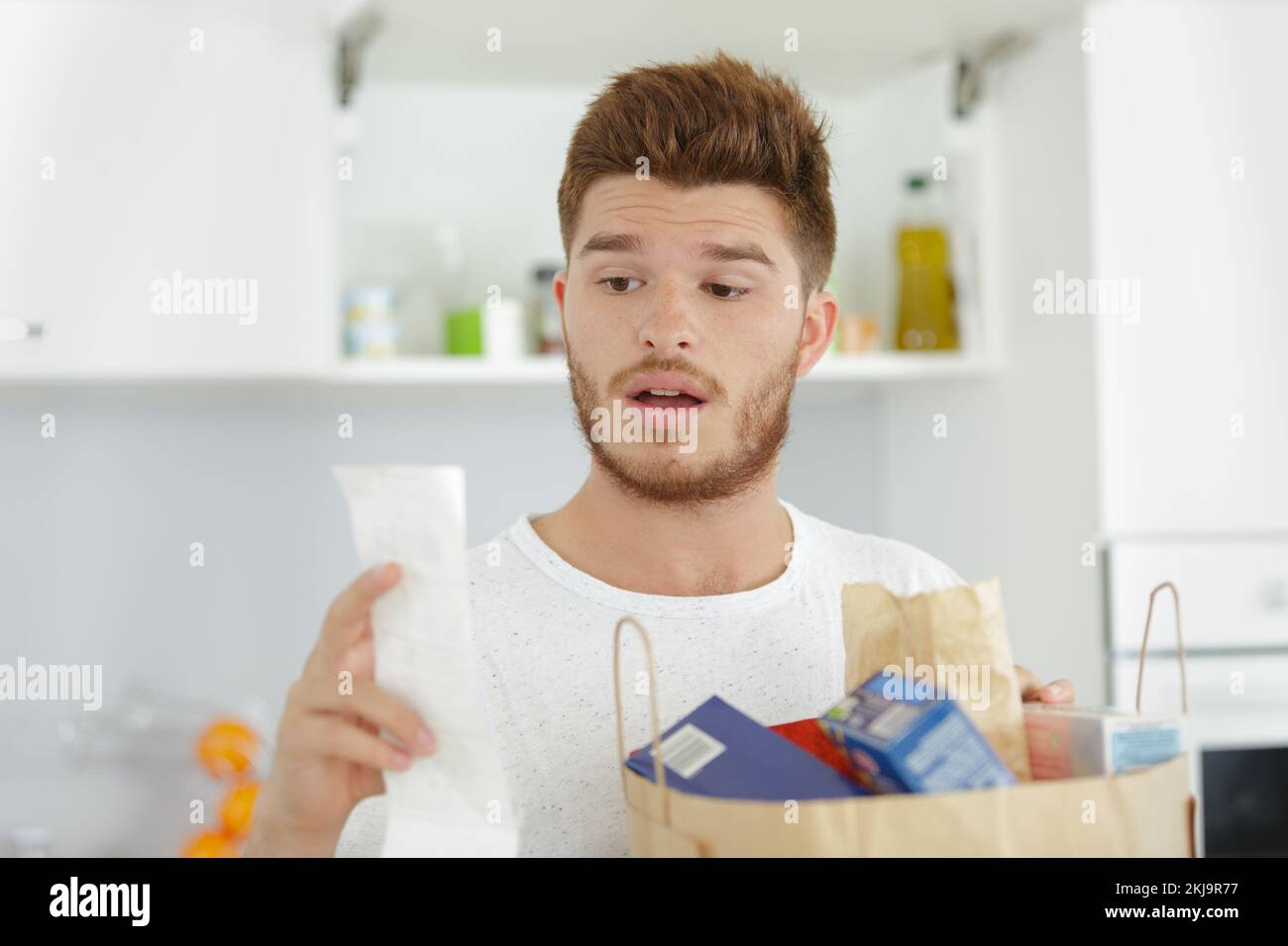 man holding an expensive bill receipt Stock Photo - Alamy