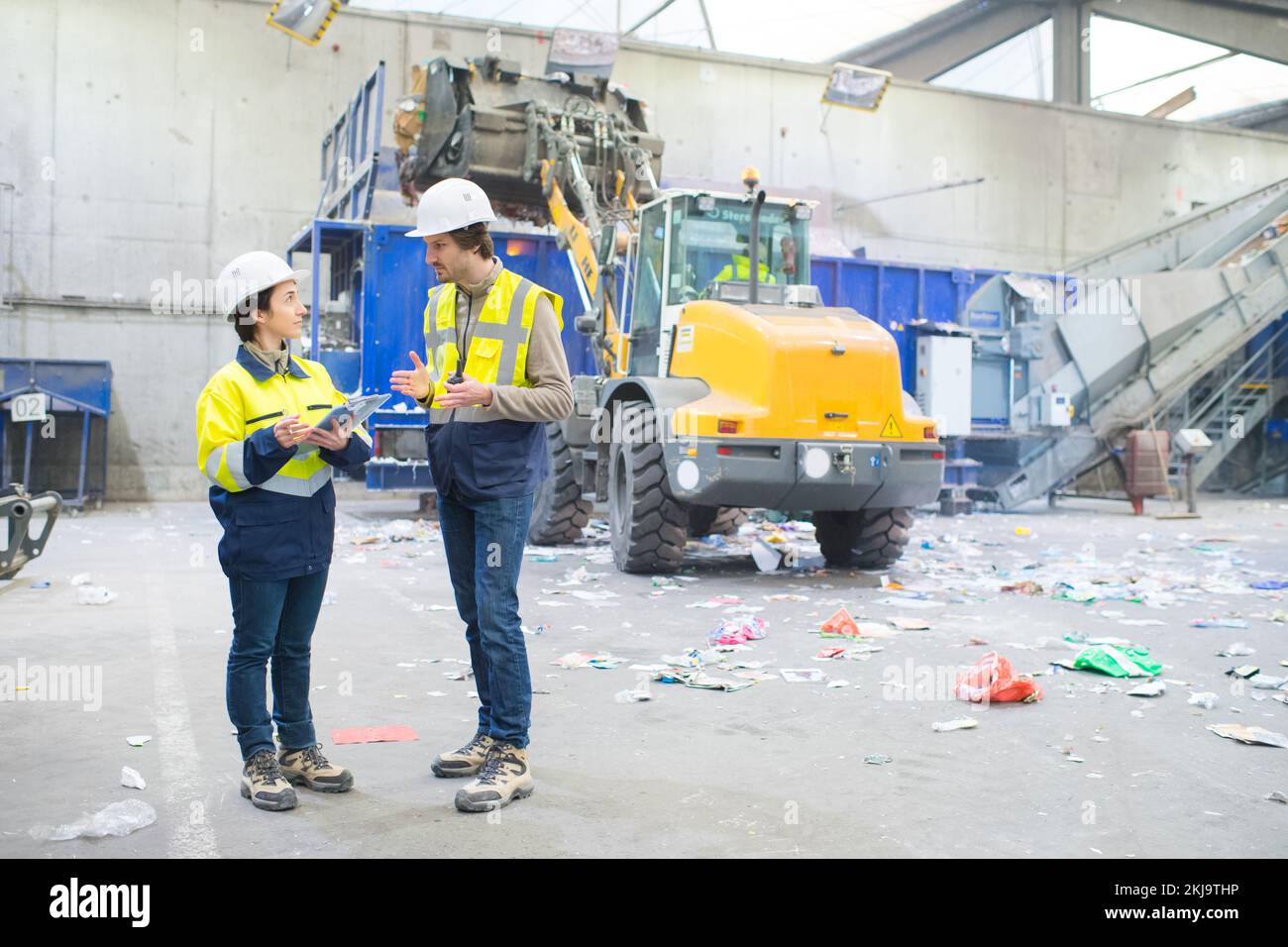 two workers talking in a recycling center Stock Photo - Alamy