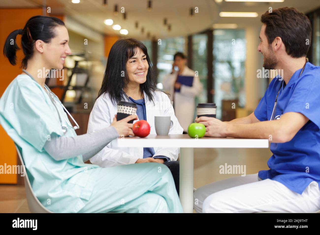 group of doctors in the cafeteria eating lunch and talking Stock Photo ...