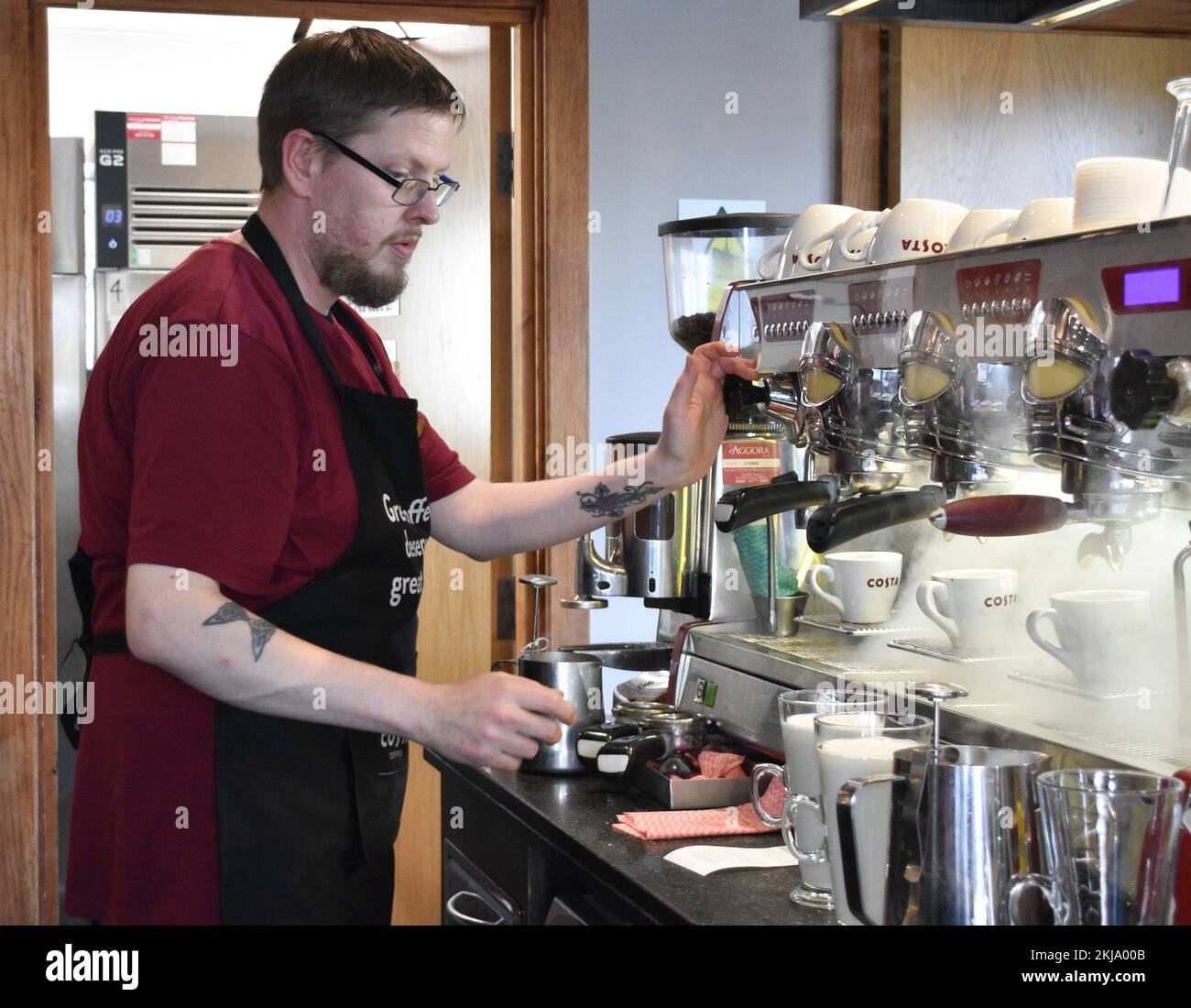 Indoor Portrait Of A Costa Coffee Worker Making Drinks For Customers ...