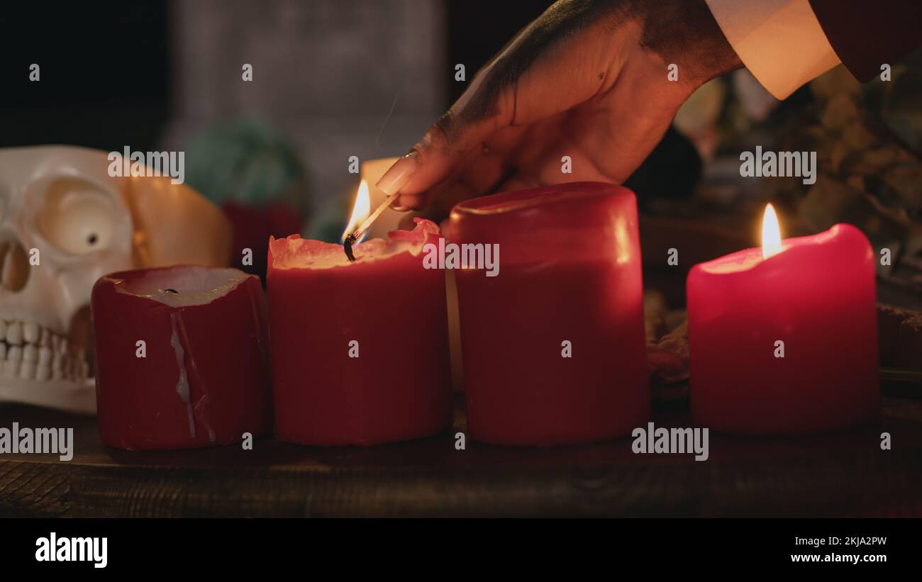 Horror model lighting candle on mexican holiday, using candle stick to ...