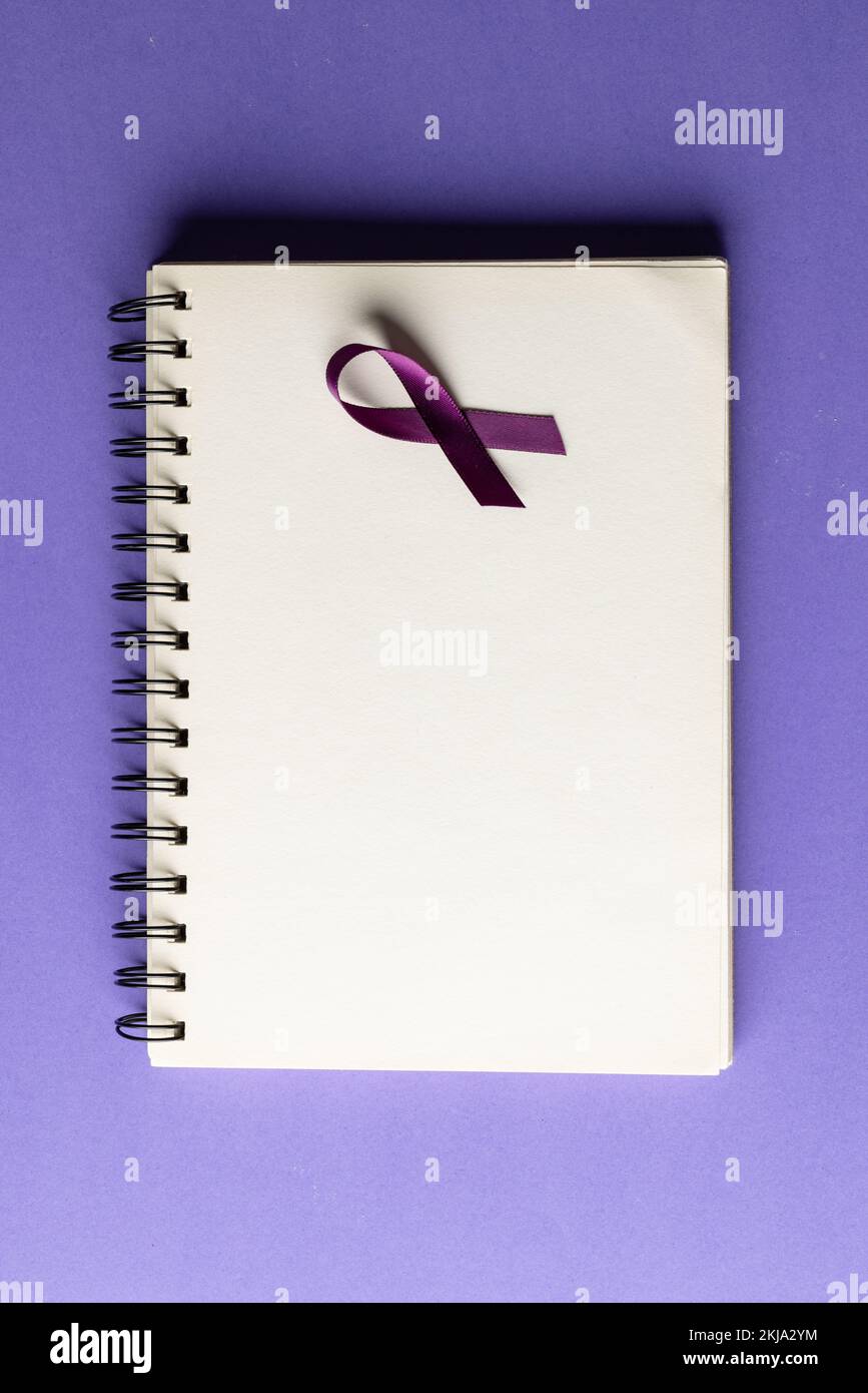 Vertical of purple add or adhd awareness ribbon on notebook with copy ...