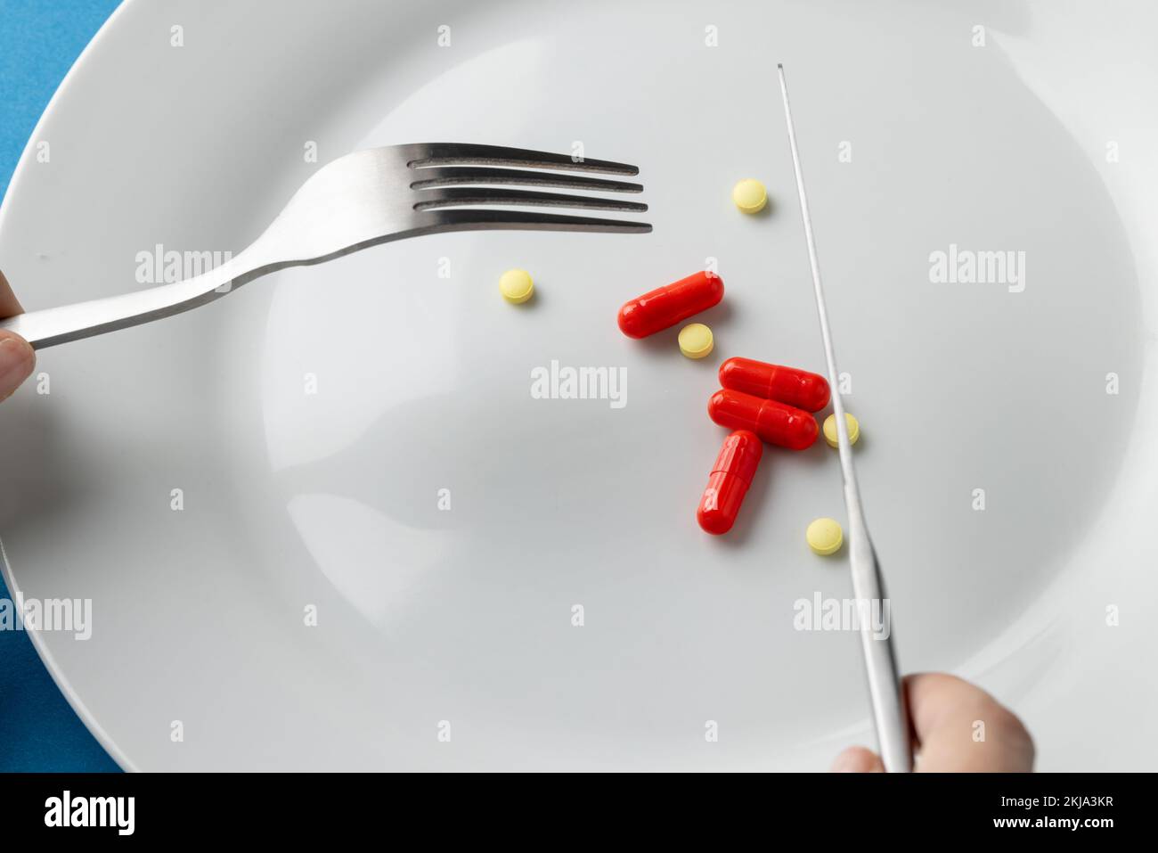Composition of hands holding fork and knife over plate with various ...