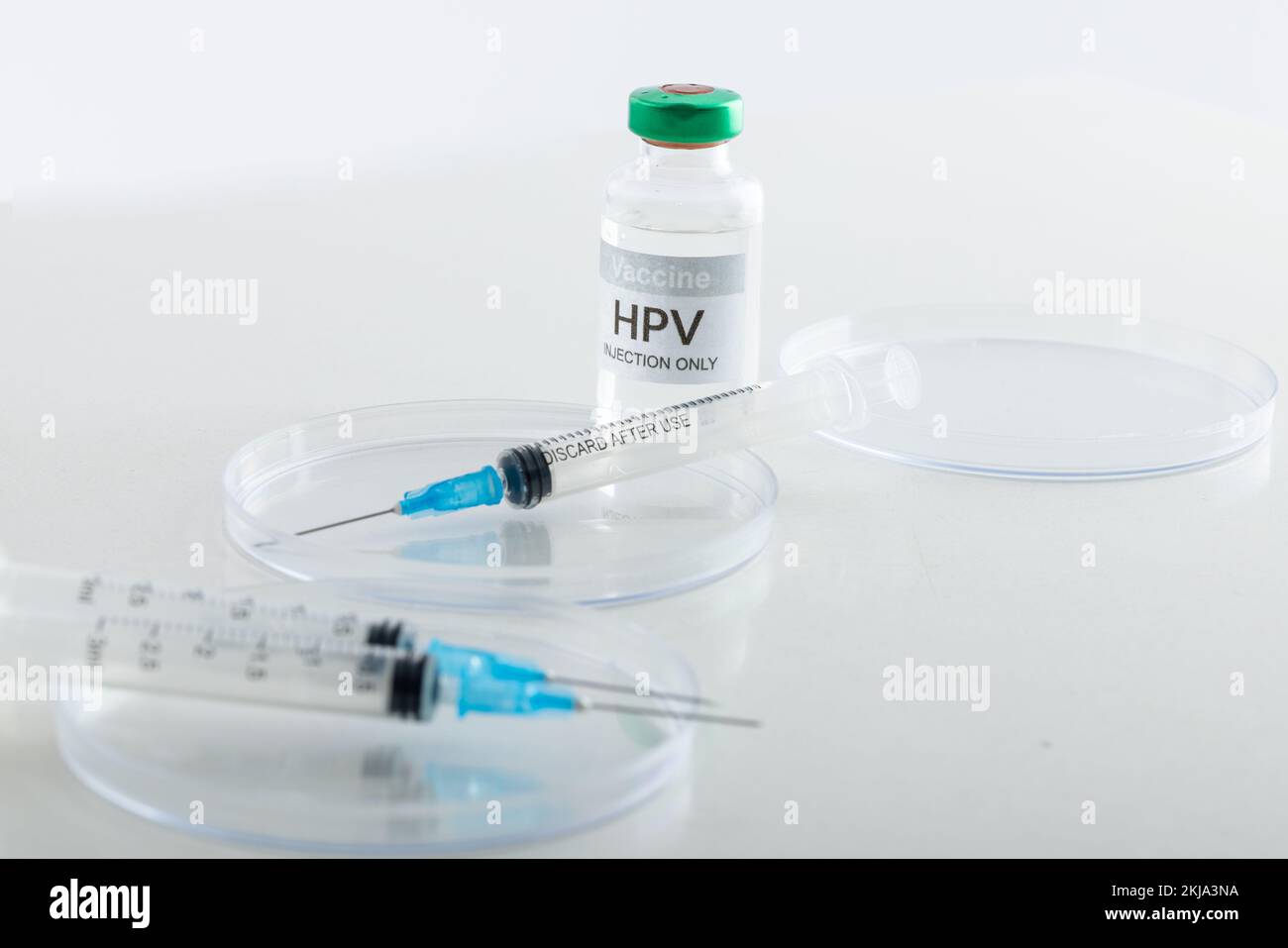 Composition of hpv vaccine vial and syringes on white background with ...